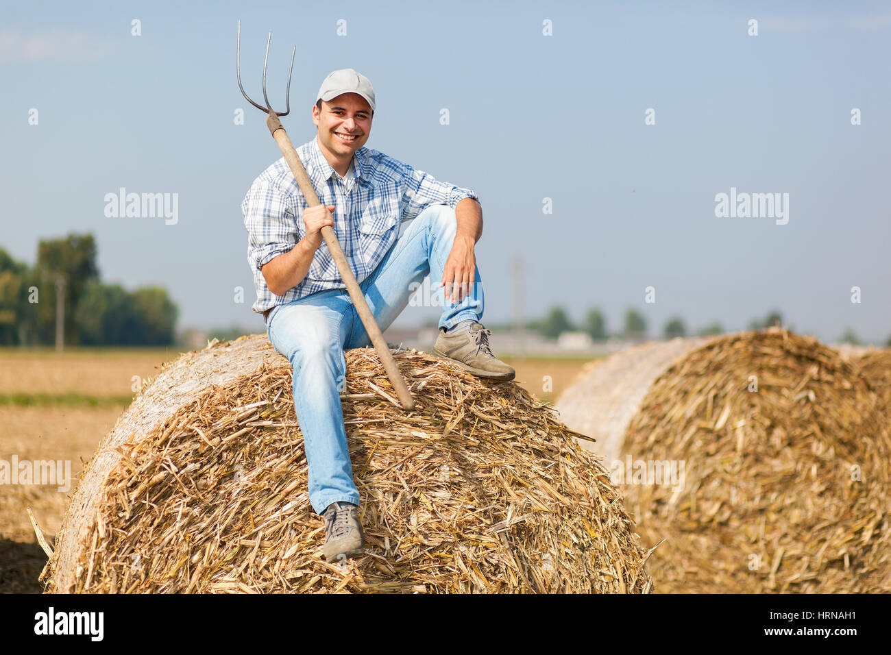 Farmer holding a pitchfork Stock Photo - Alamy