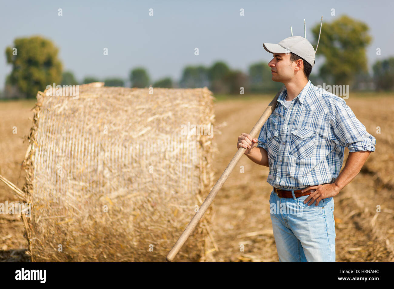 Farmer holding a pitchfork Stock Photo - Alamy