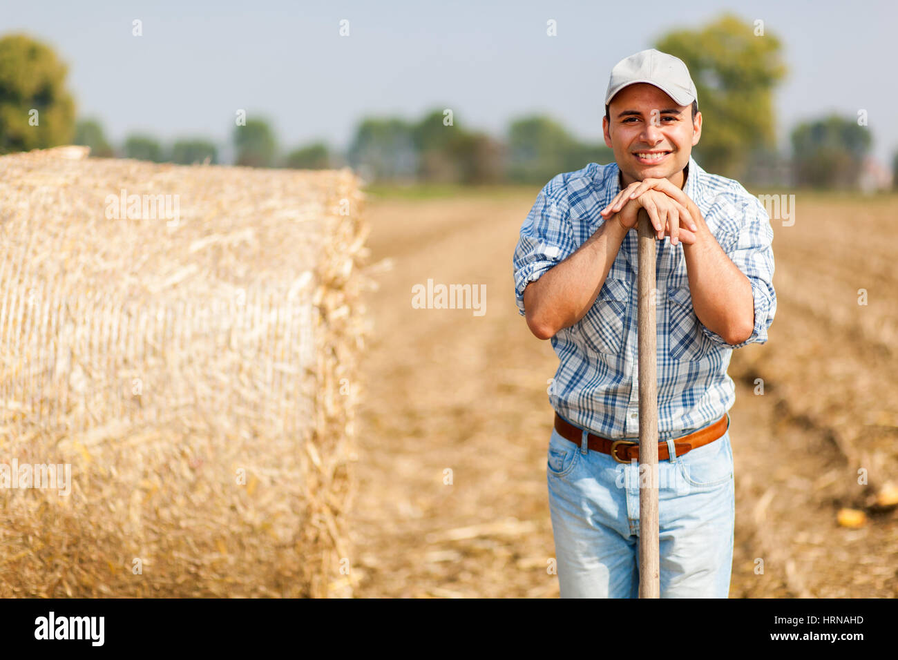Farmer holding a pitchfork Stock Photo - Alamy