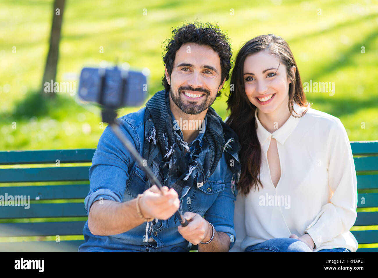 Couple using a selfie stick Stock Photo - Alamy