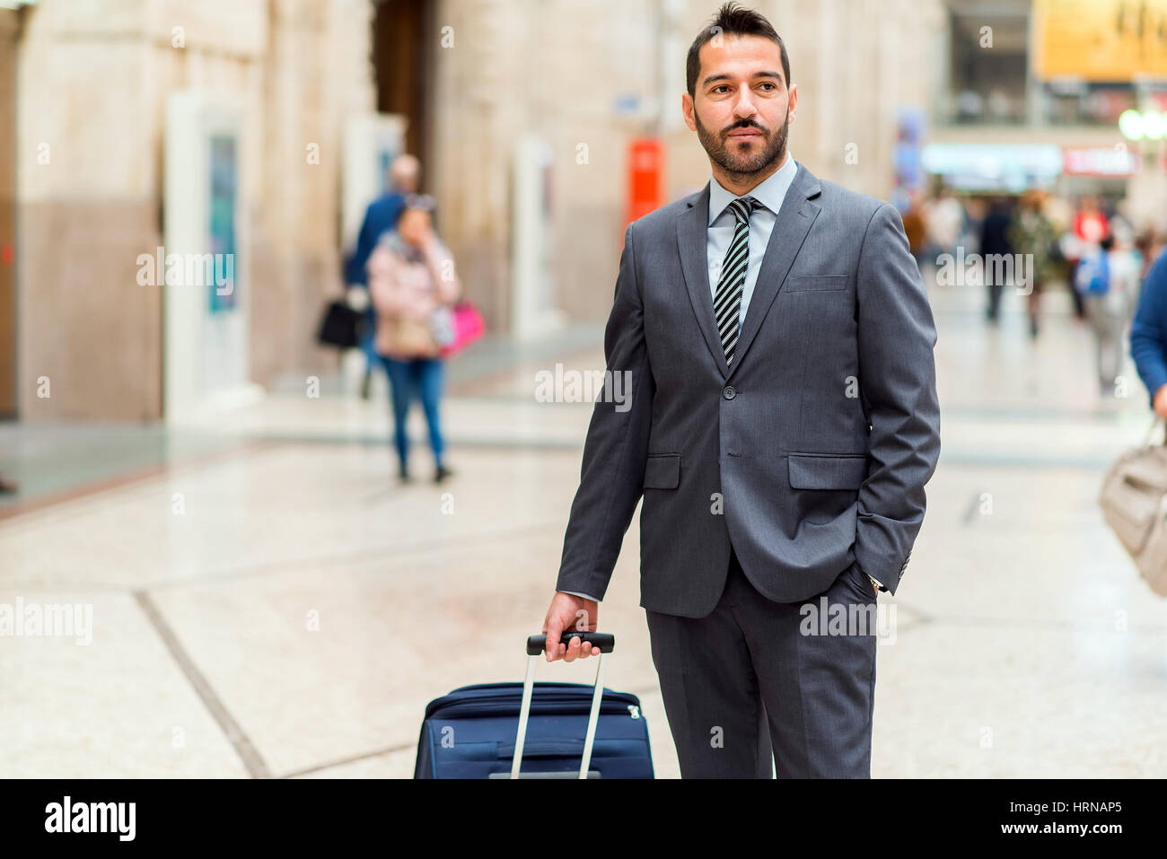 Man walking with a trolley at the station Stock Photo - Alamy