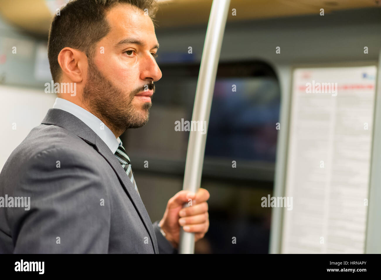 Portrait of a man traveling in a subway train Stock Photo - Alamy