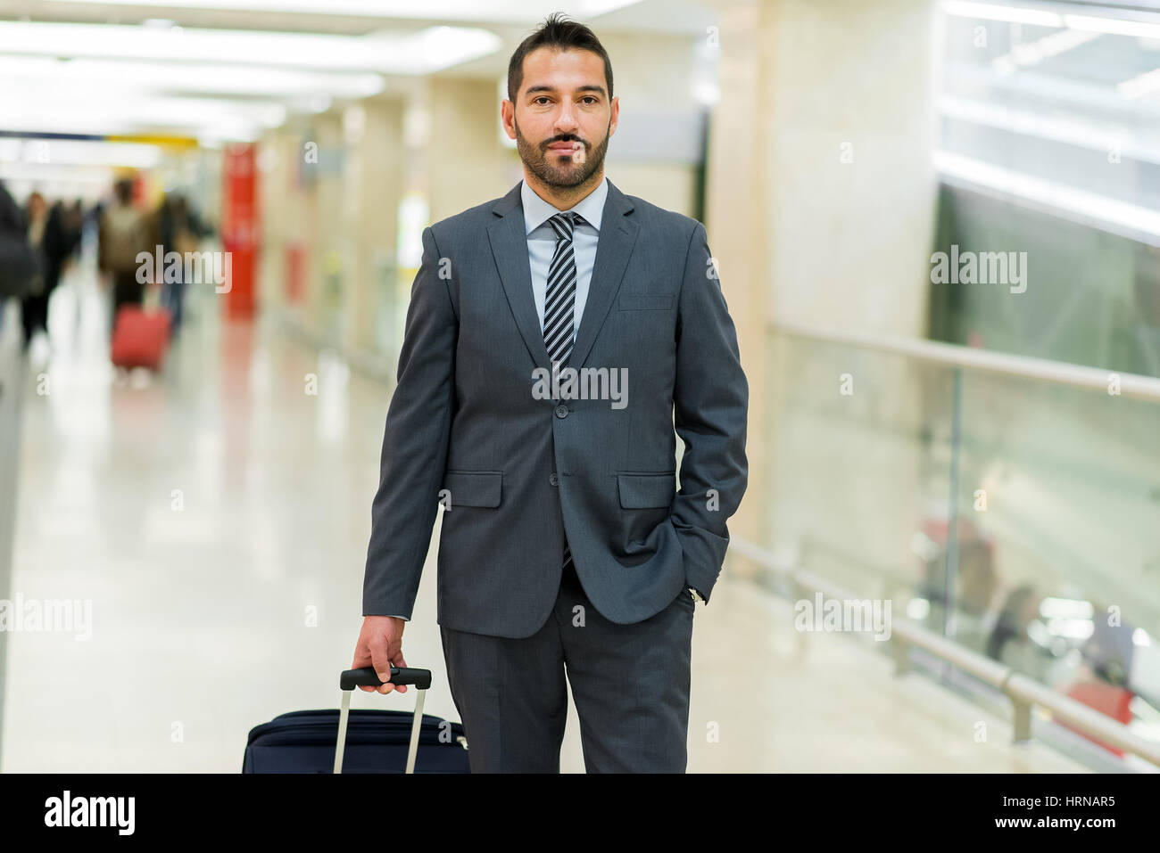 Man walking with a trolley at the station Stock Photo - Alamy
