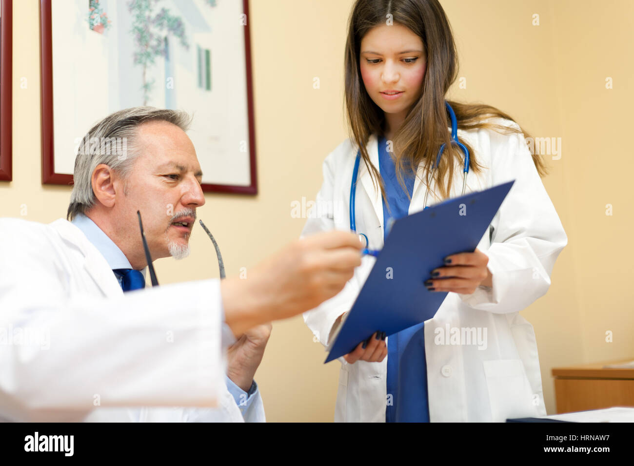 Portrait of a doctor and his assistant in his studio Stock Photo - Alamy