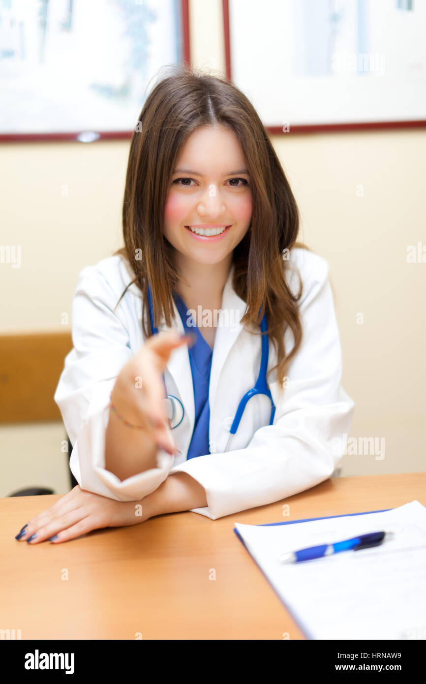 Young female doctor giving her hand Stock Photo - Alamy