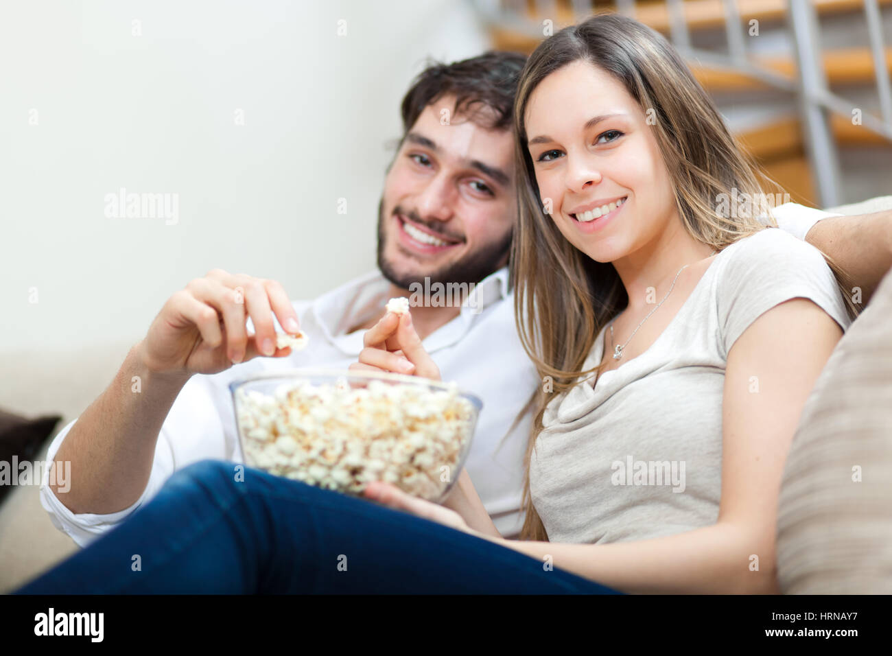 Couple watching a movie in their house Stock Photo - Alamy