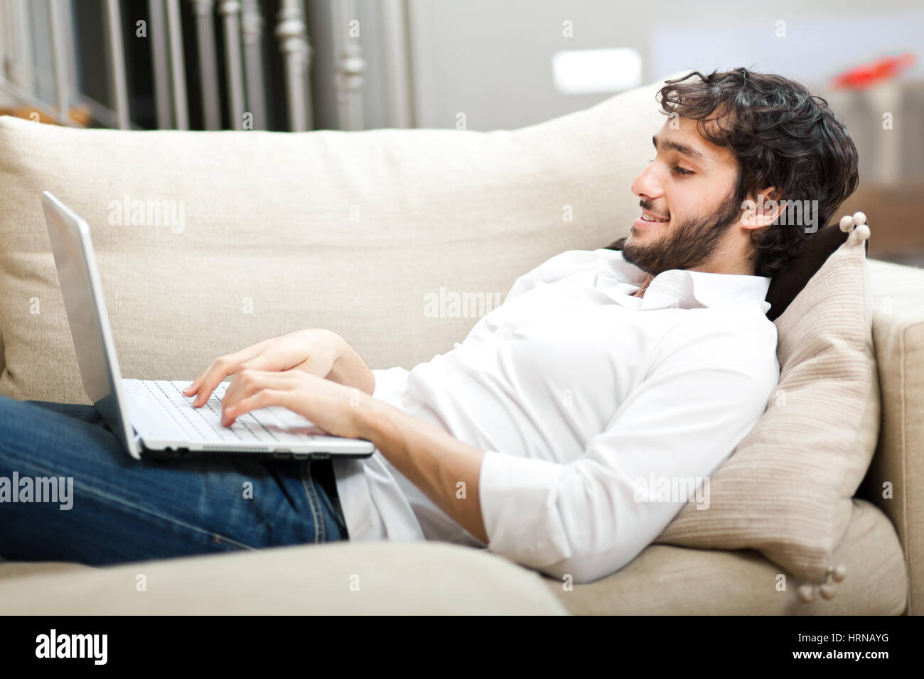 Man using a laptop computer Stock Photo - Alamy