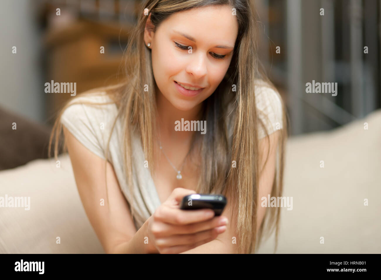 Woman sending a text message Stock Photo - Alamy