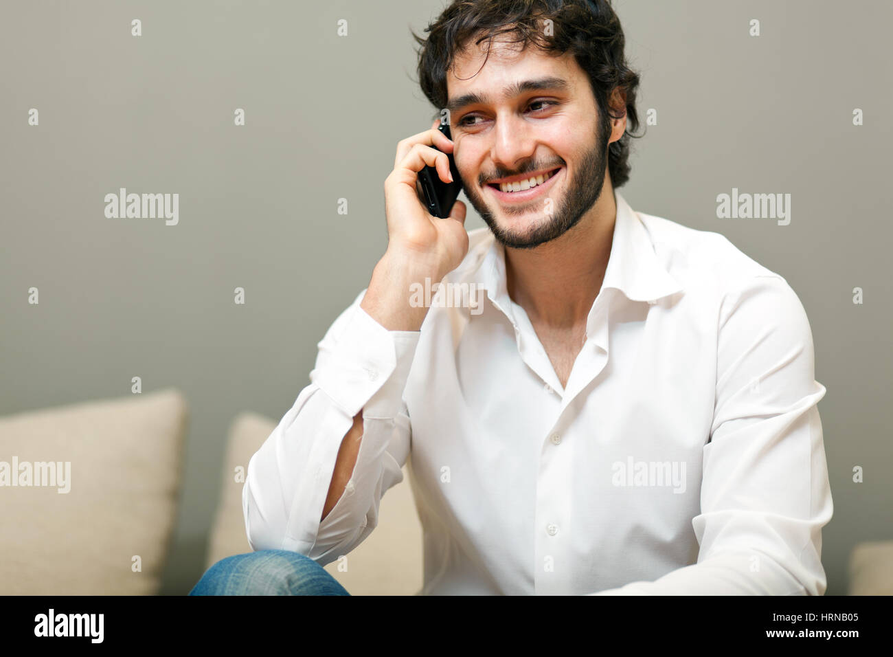 Young man talking on the phone Stock Photo - Alamy