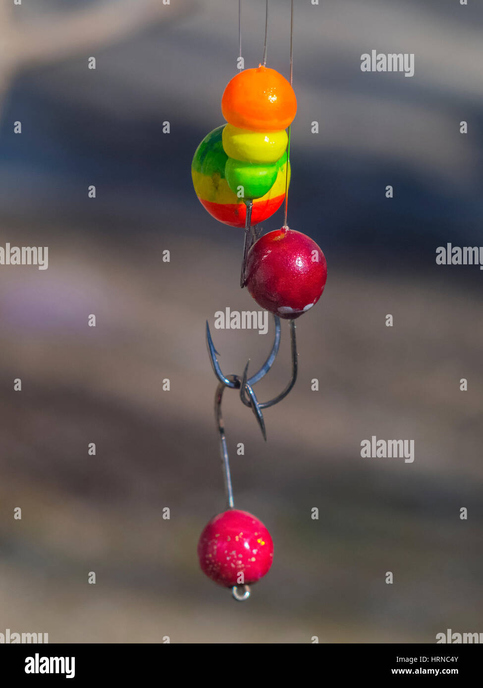 Four colorful floats with the hooks for fishing Stock Photo - Alamy