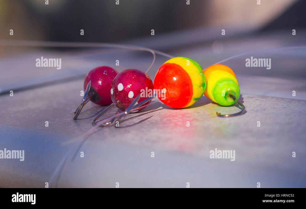 Four nice colorful floats with a hooks for fishing Stock Photo - Alamy