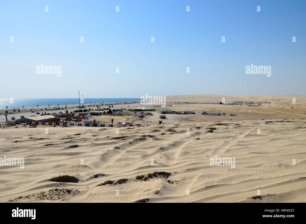 Desert base camp with camels and tent. Tracks of 4X4 vehicles used in ...
