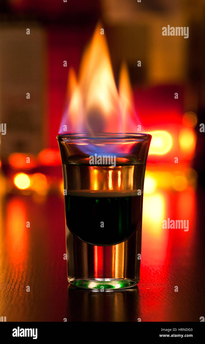 Burning cocktail in shot glass on a table, shallow focus Stock Photo ...