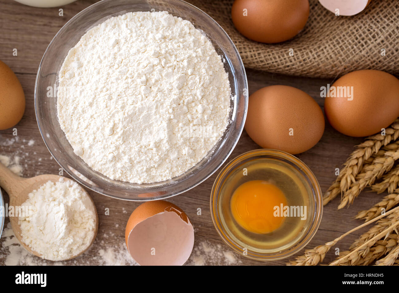 eggs and flour basic ingredients for baking on wooden table top view ...