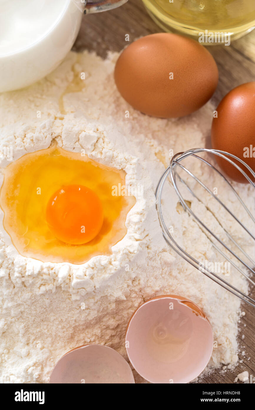 top view breaking egg and flour on wooden table Stock Photo - Alamy