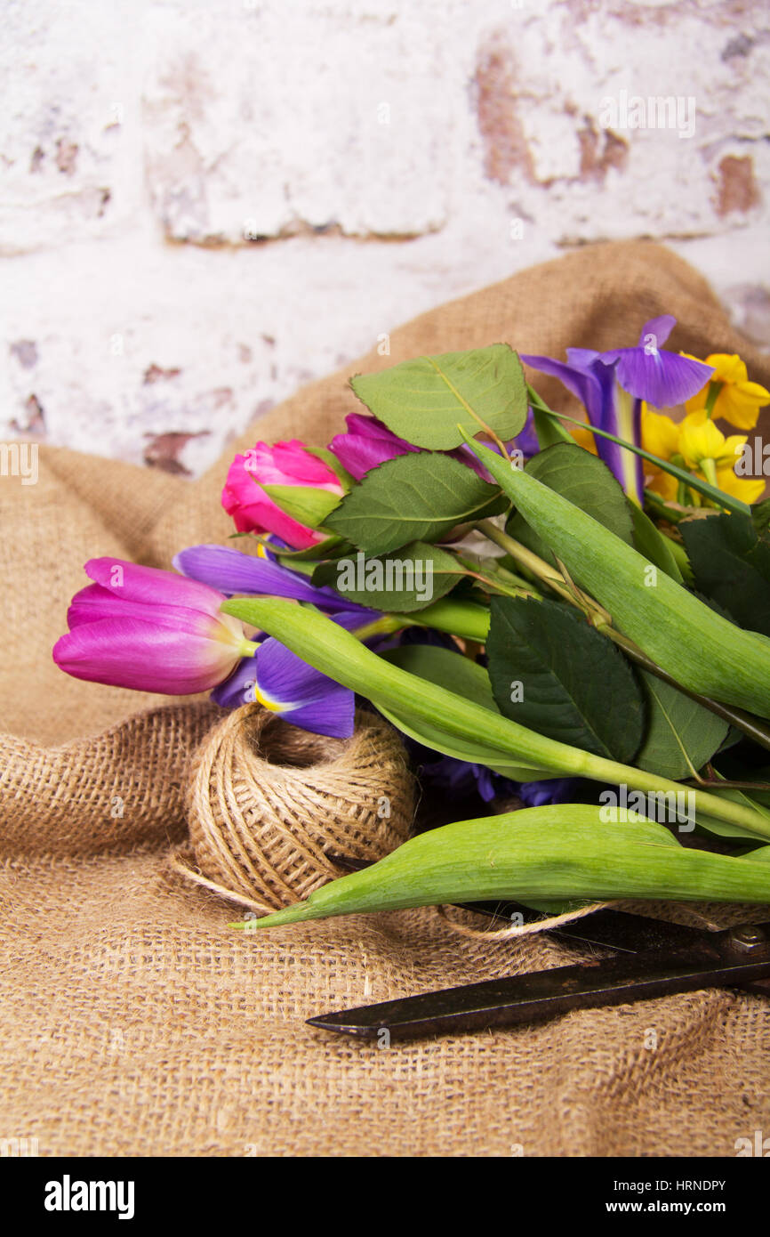 Spring cut flower arrangement against a rustic background Stock Photo ...