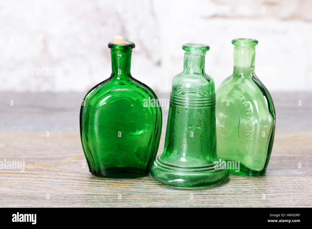 Selection of coloured glass bottles on a rustic background Stock Photo ...