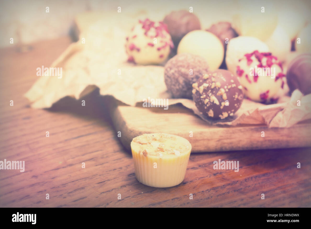 Selection of delicious chocolates on rustic background Stock Photo - Alamy