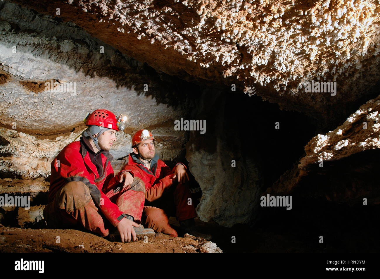 Spelunkers in a cave Stock Photo - Alamy