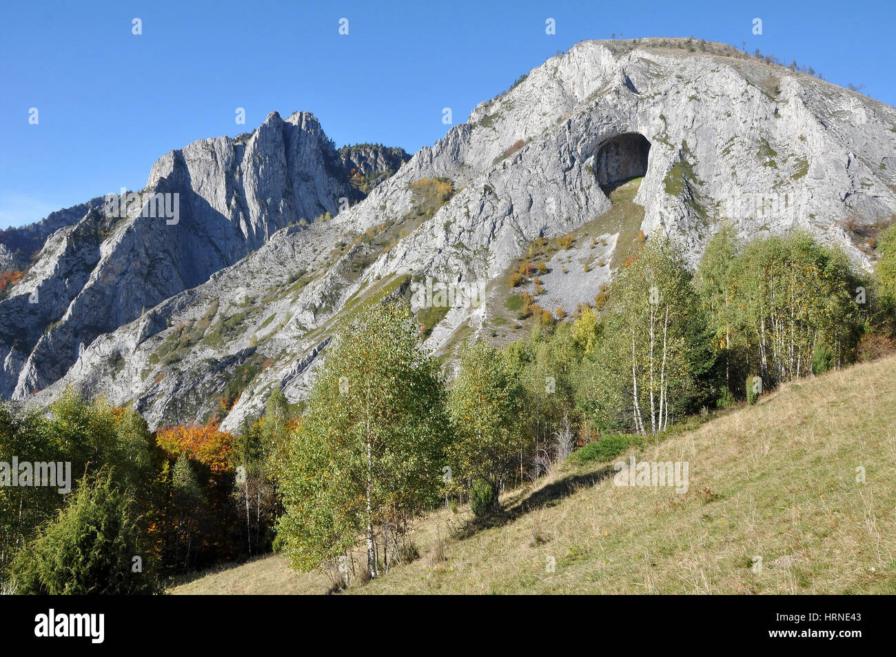 Limestone mountain with a big cave entrance Stock Photo - Alamy