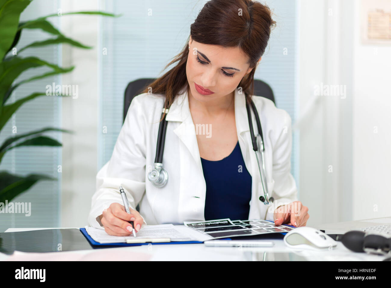 Doctor at work in her office Stock Photo - Alamy
