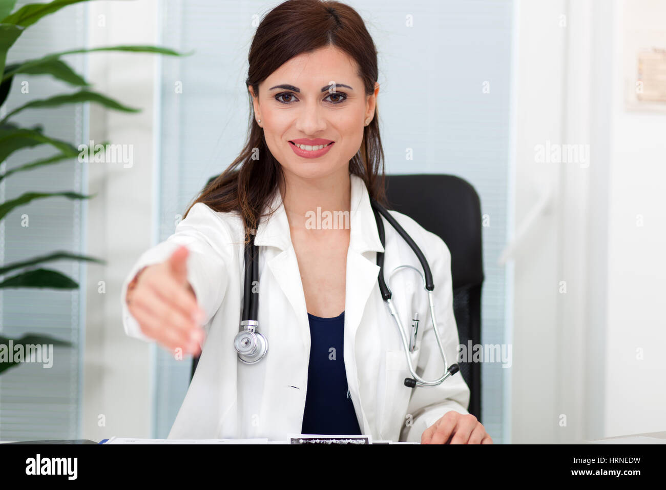 Doctor welcoming a patient in her studio Stock Photo - Alamy