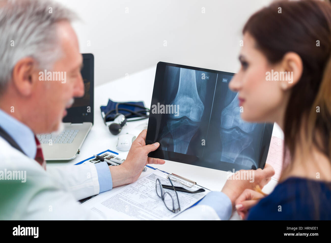 Doctor showing a radiography to his patient Stock Photo - Alamy