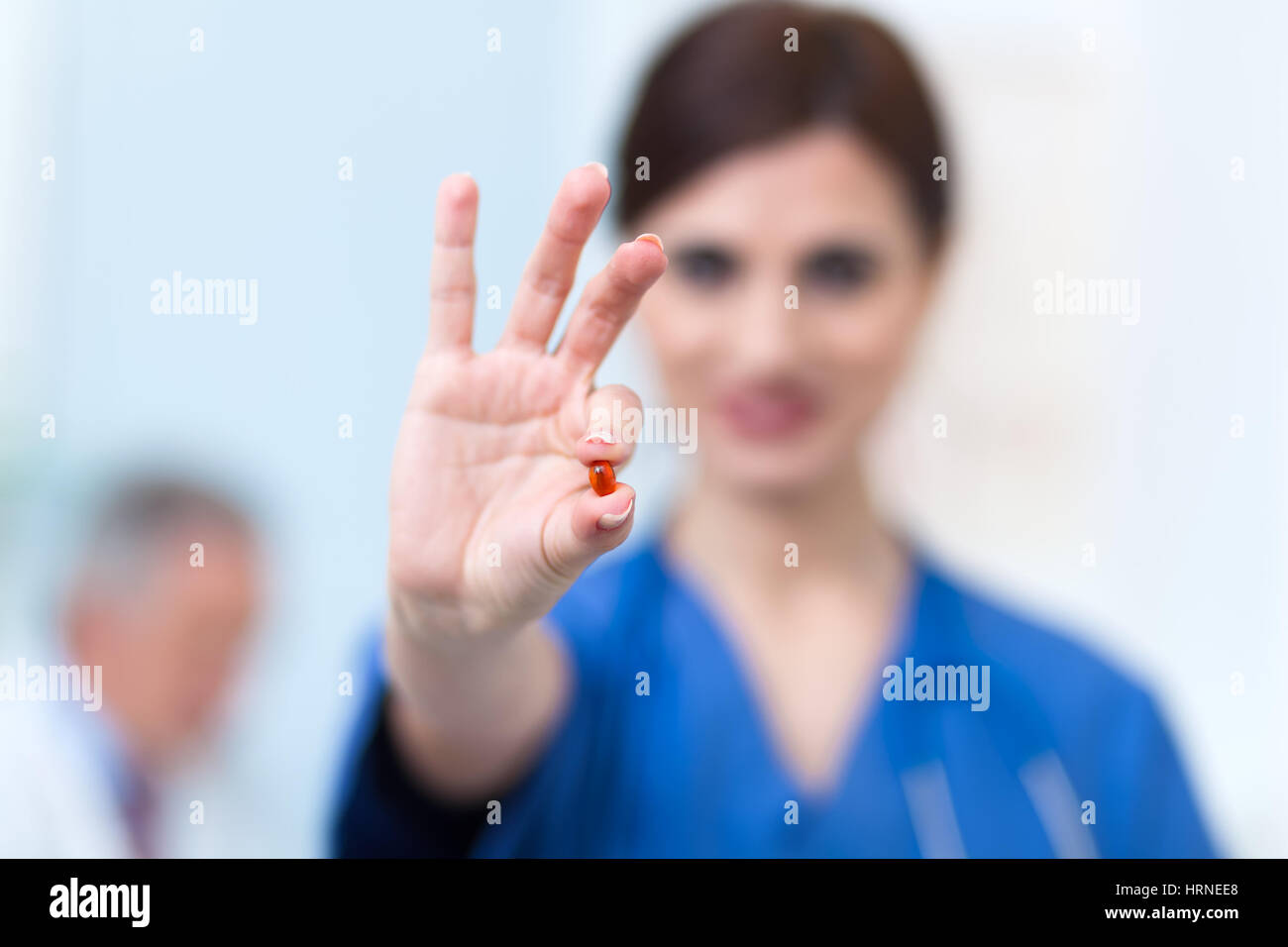 Nurse holding a pill Stock Photo - Alamy