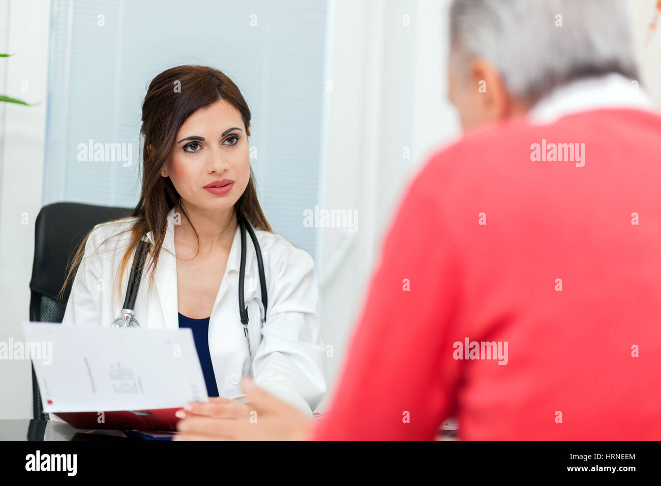 Doctor talking to her patient in her office Stock Photo - Alamy