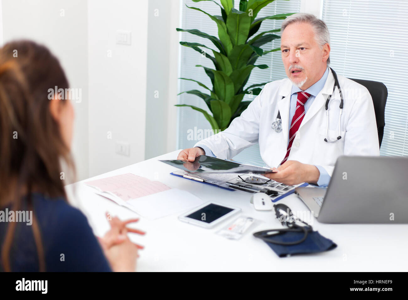 Doctor talking to a patient in his studio Stock Photo - Alamy