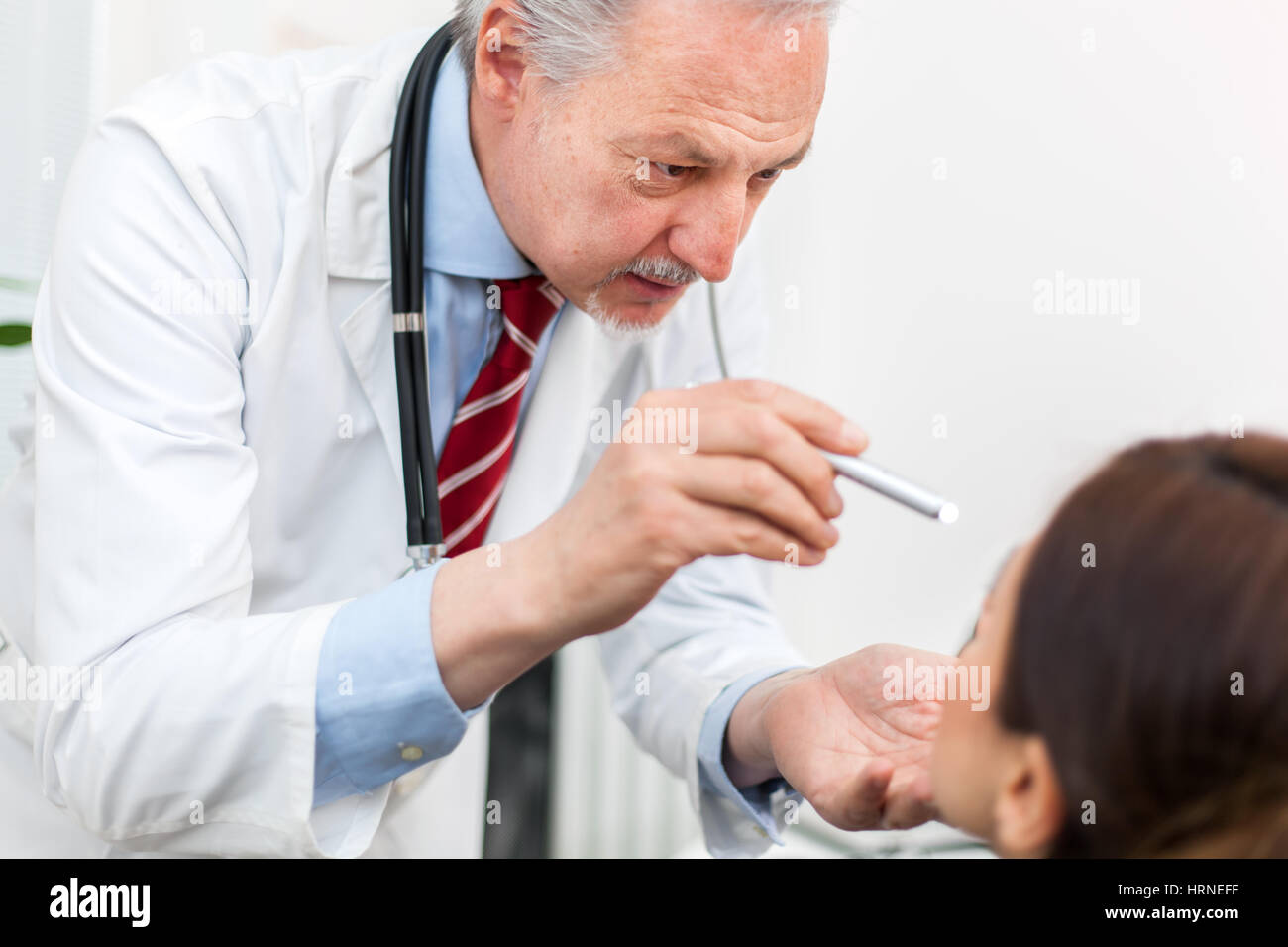 Doctor examining a patient in his office Stock Photo - Alamy