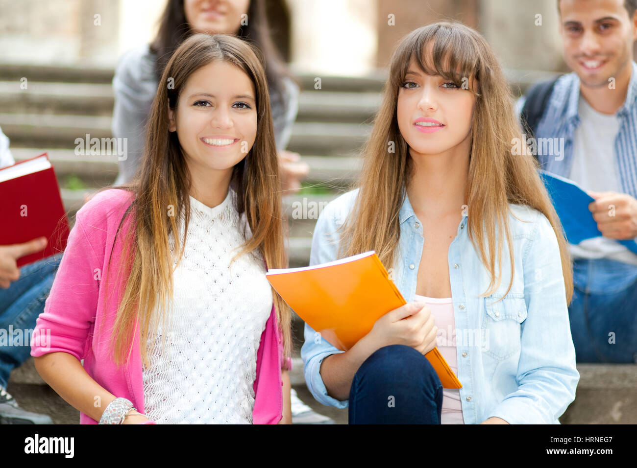 Students group sitting outdoor Stock Photo - Alamy