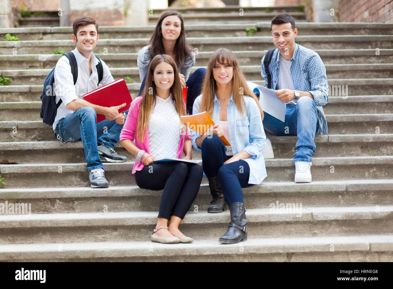 Students group sitting outdoor Stock Photo - Alamy