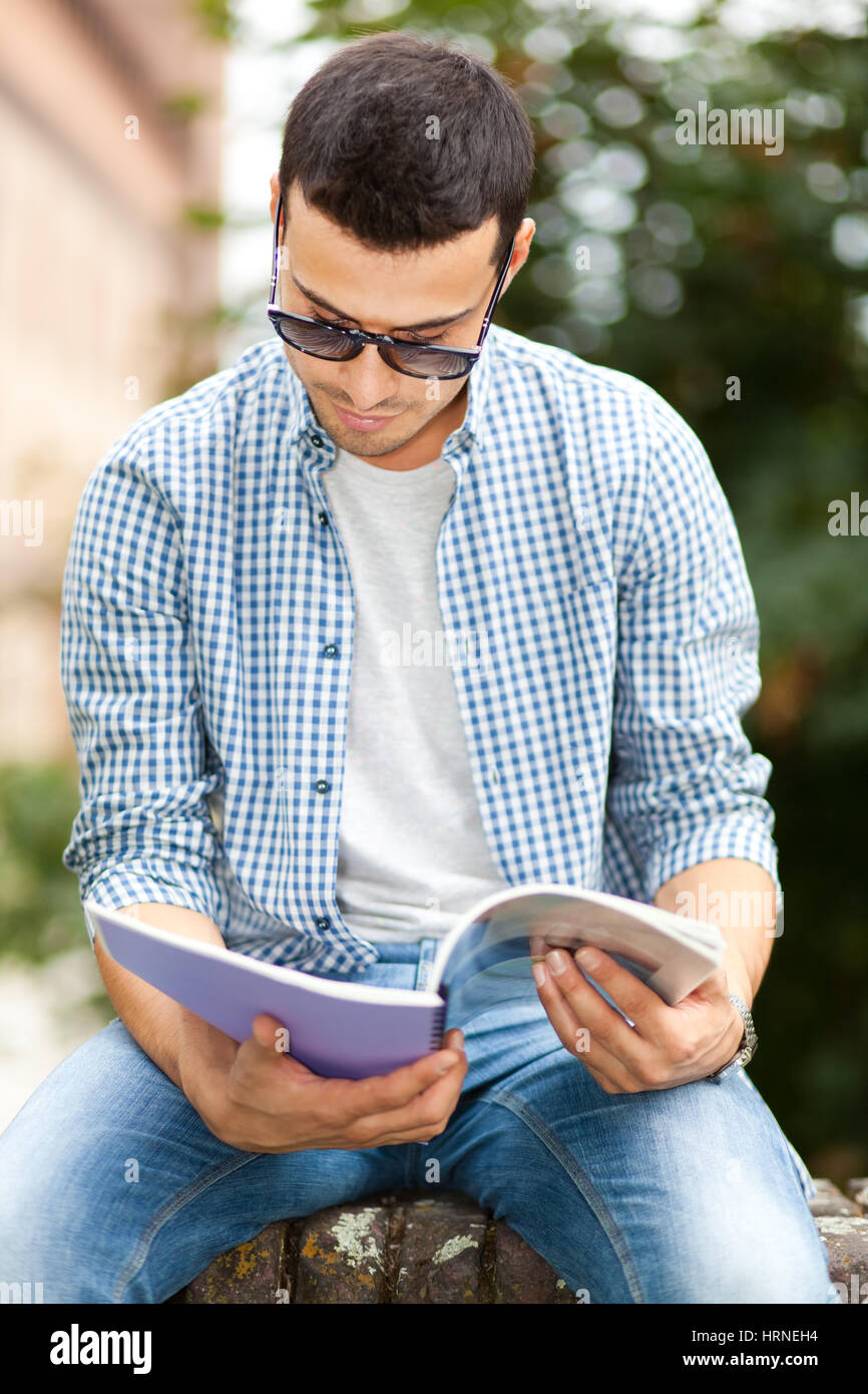 Student reading a book Stock Photo - Alamy