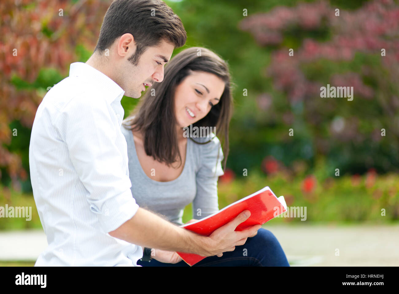 Couple of students at the park Stock Photo - Alamy
