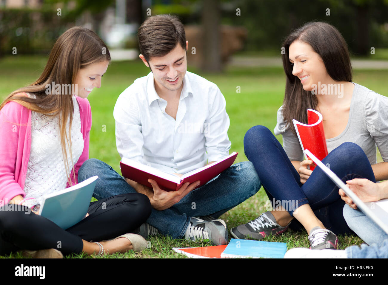 Students sitting at the park Stock Photo - Alamy