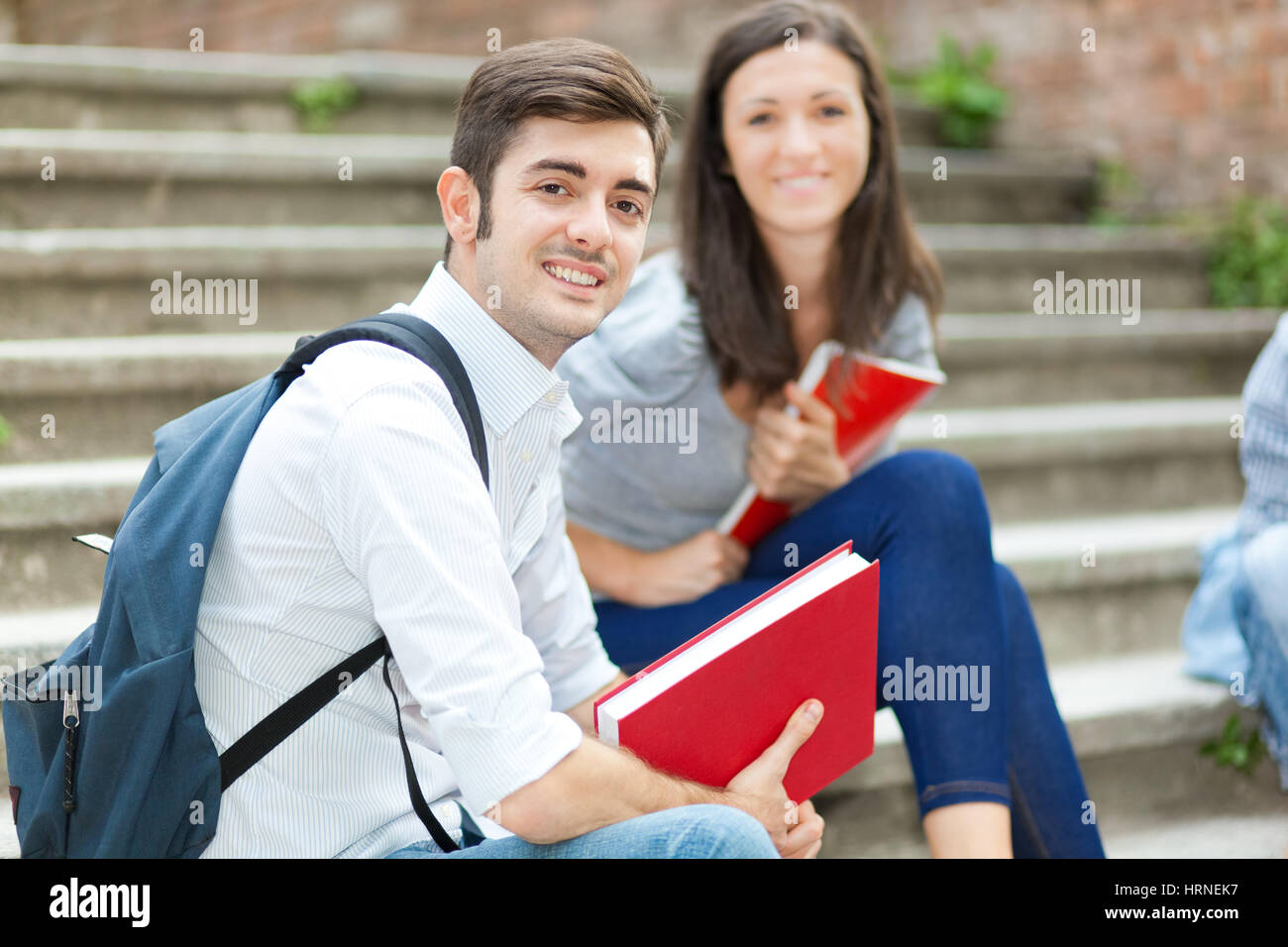 Students sitting outside Stock Photo - Alamy