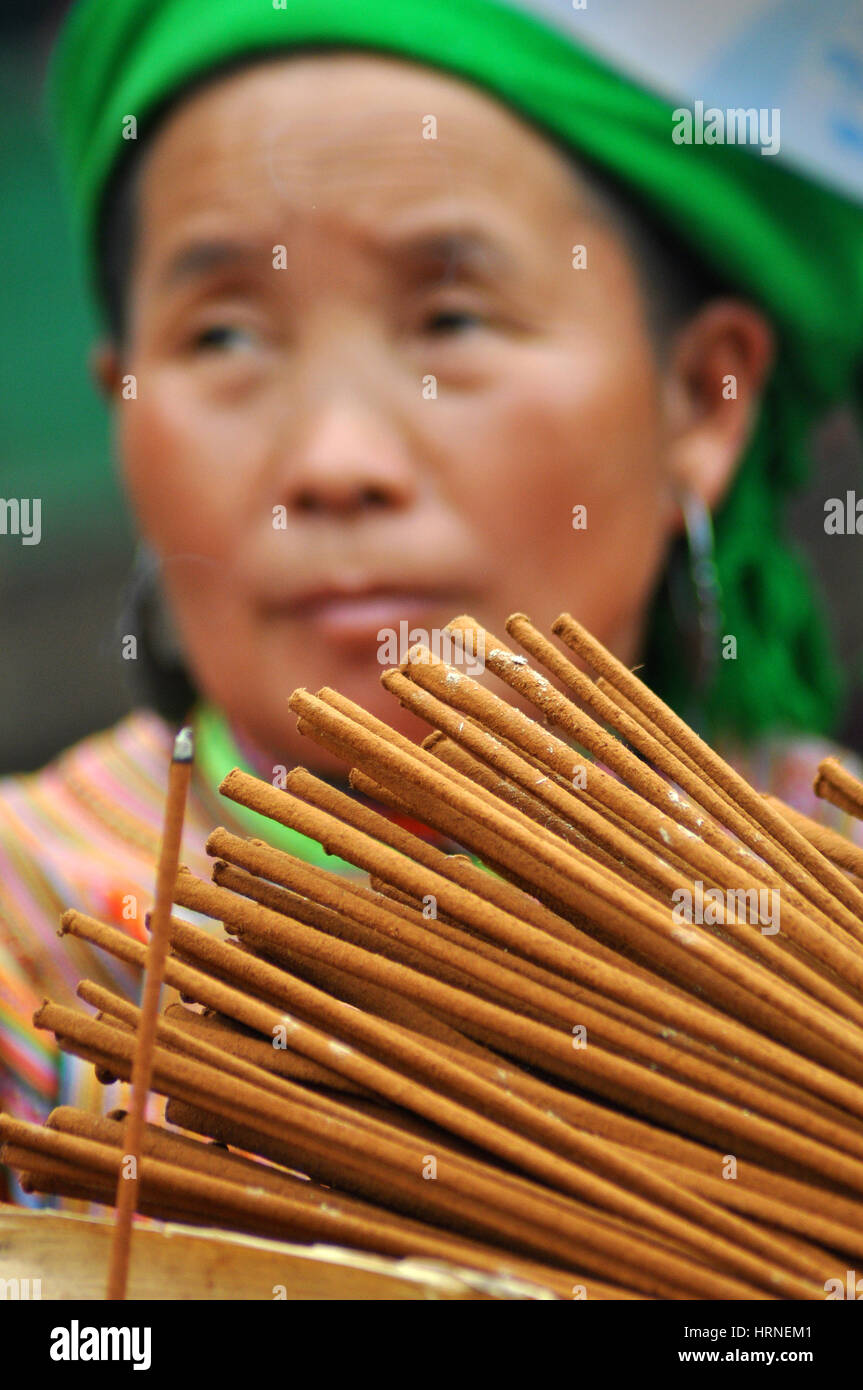 SAPA, VIETNAM - FEBRUARY 22, 2013: Hmong woman selling incense sticks ...