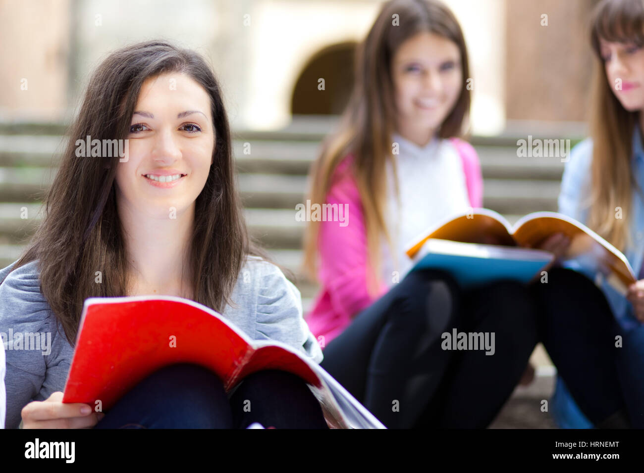 Students sitting outside Stock Photo - Alamy