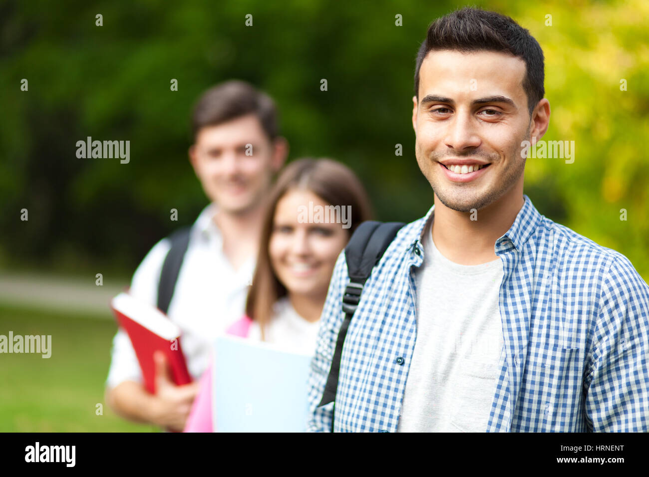 Smiling students group at the park Stock Photo - Alamy