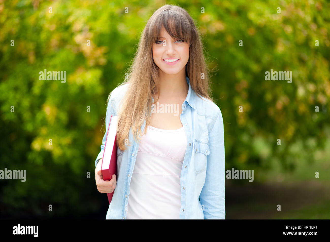 Smiling female student at the park Stock Photo - Alamy