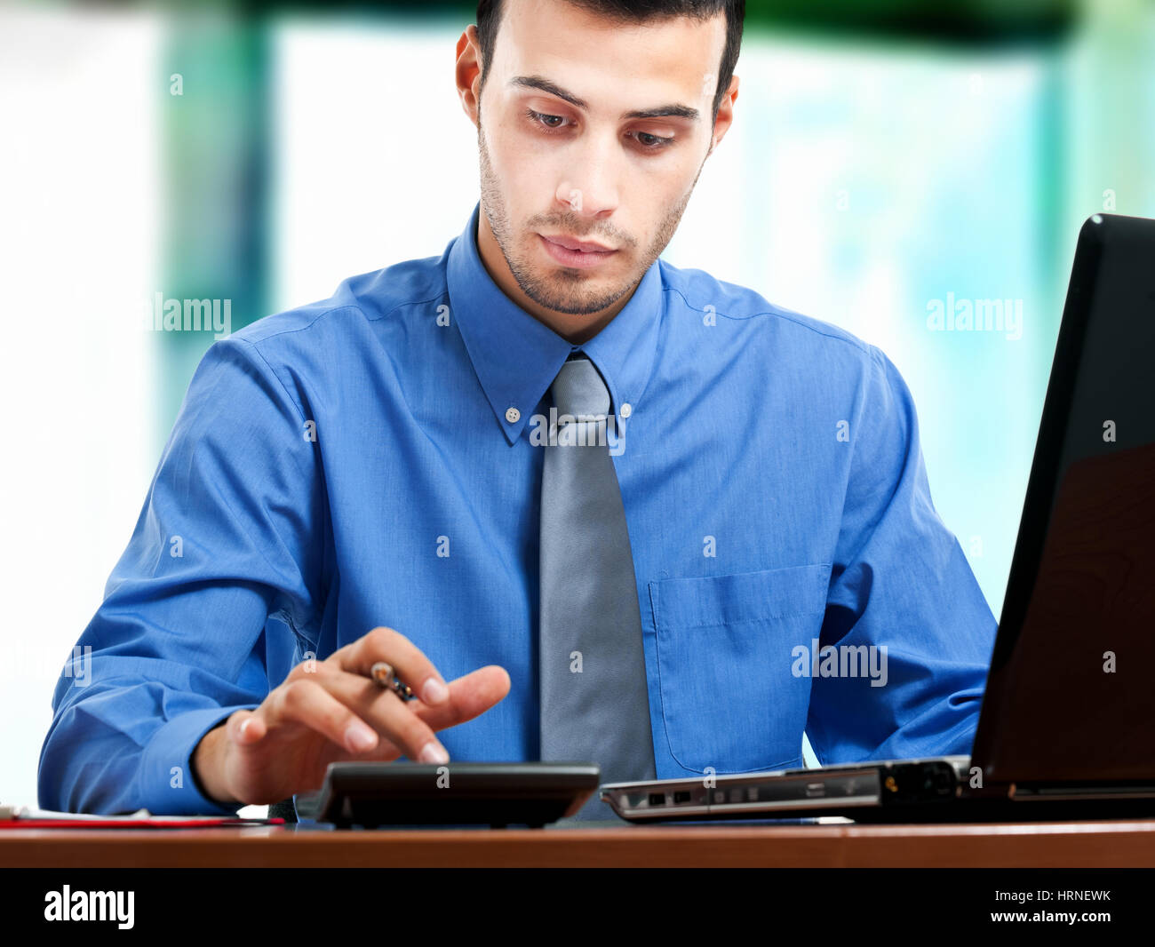 Businessman using his calculator Stock Photo - Alamy