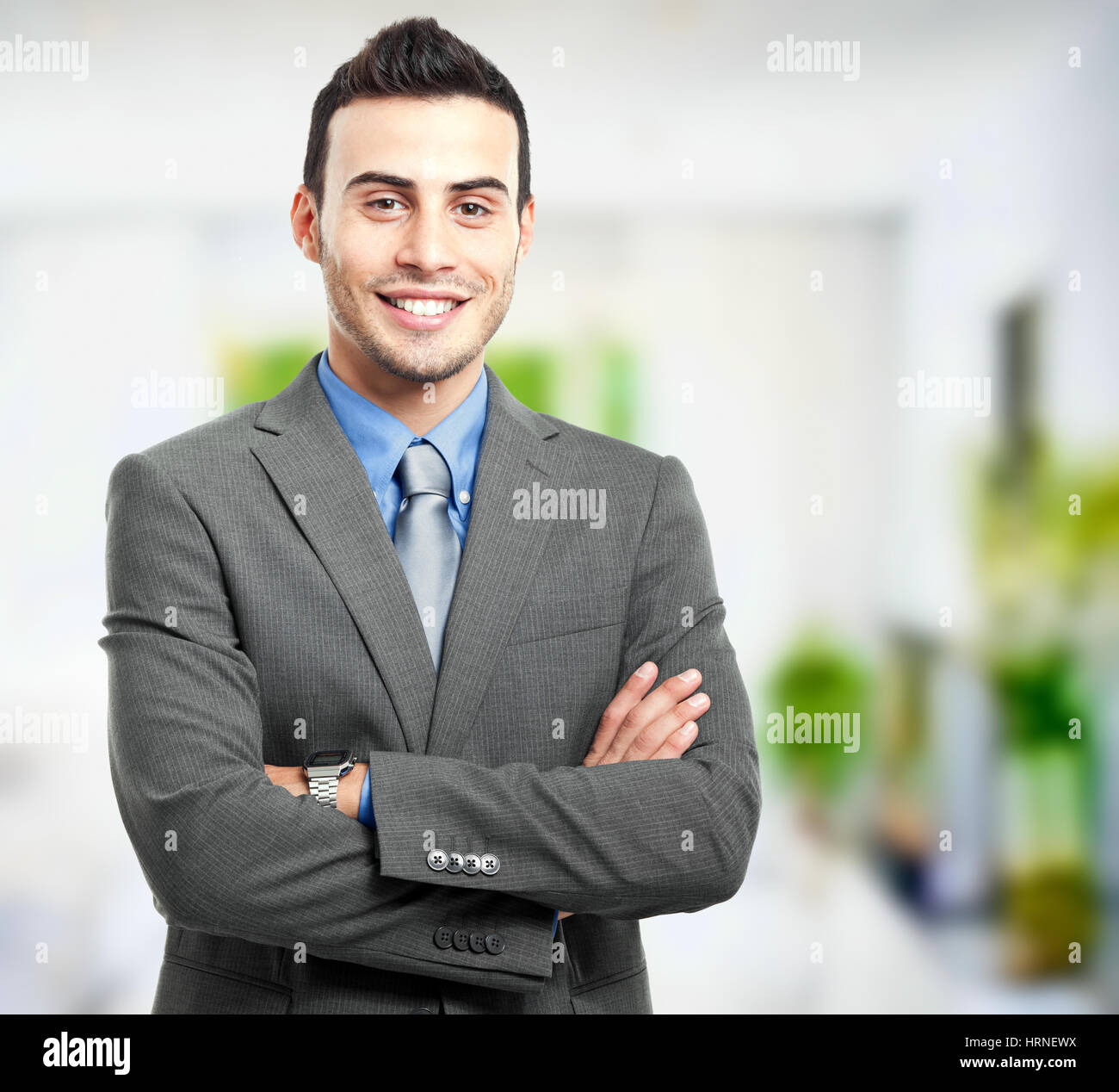 Smiling manager with folded arms Stock Photo - Alamy