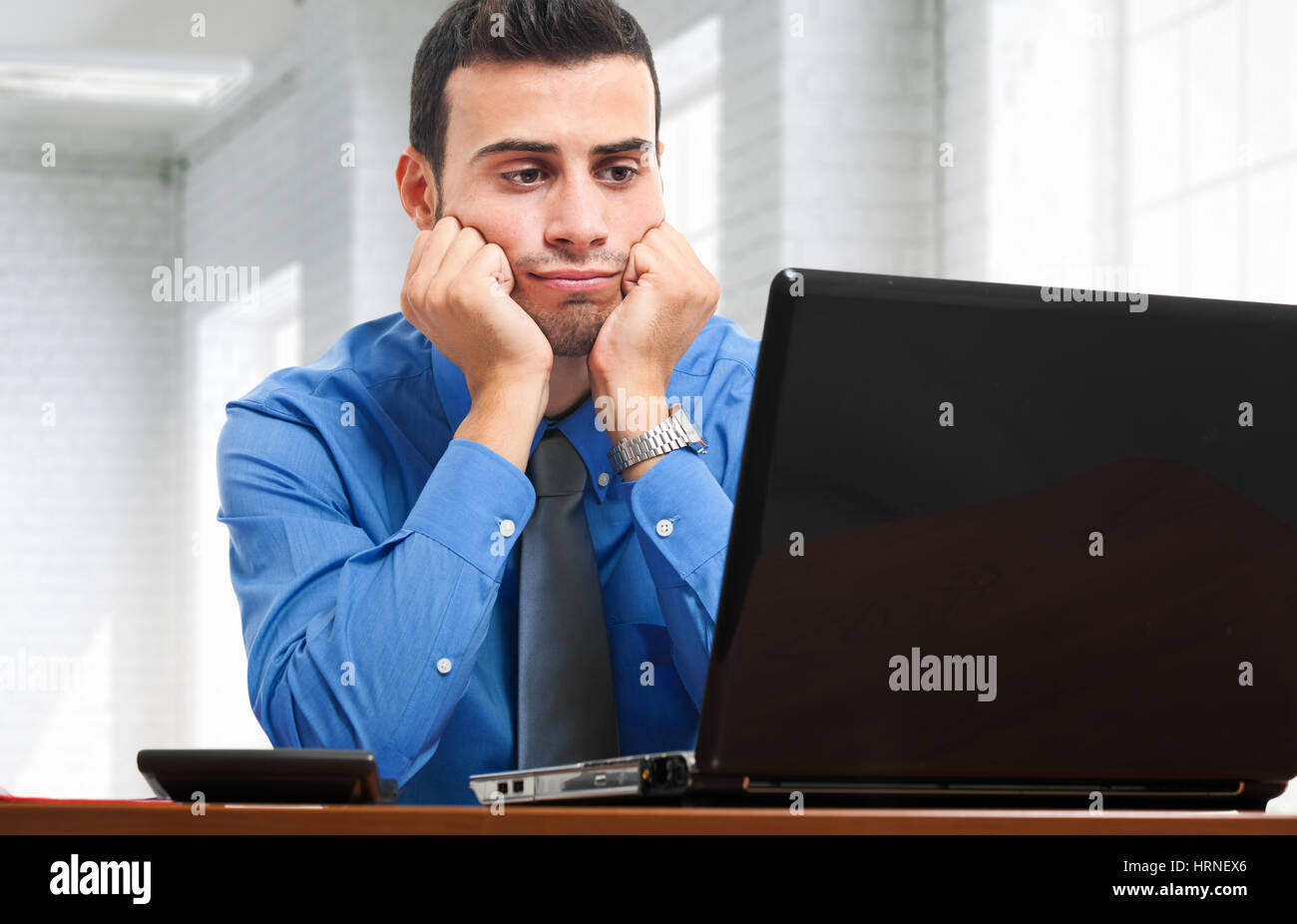 Bored businessman at his desk in the office Stock Photo - Alamy