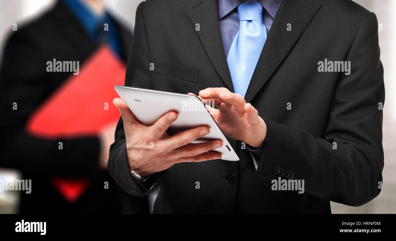 Businessman using his tablet Stock Photo - Alamy