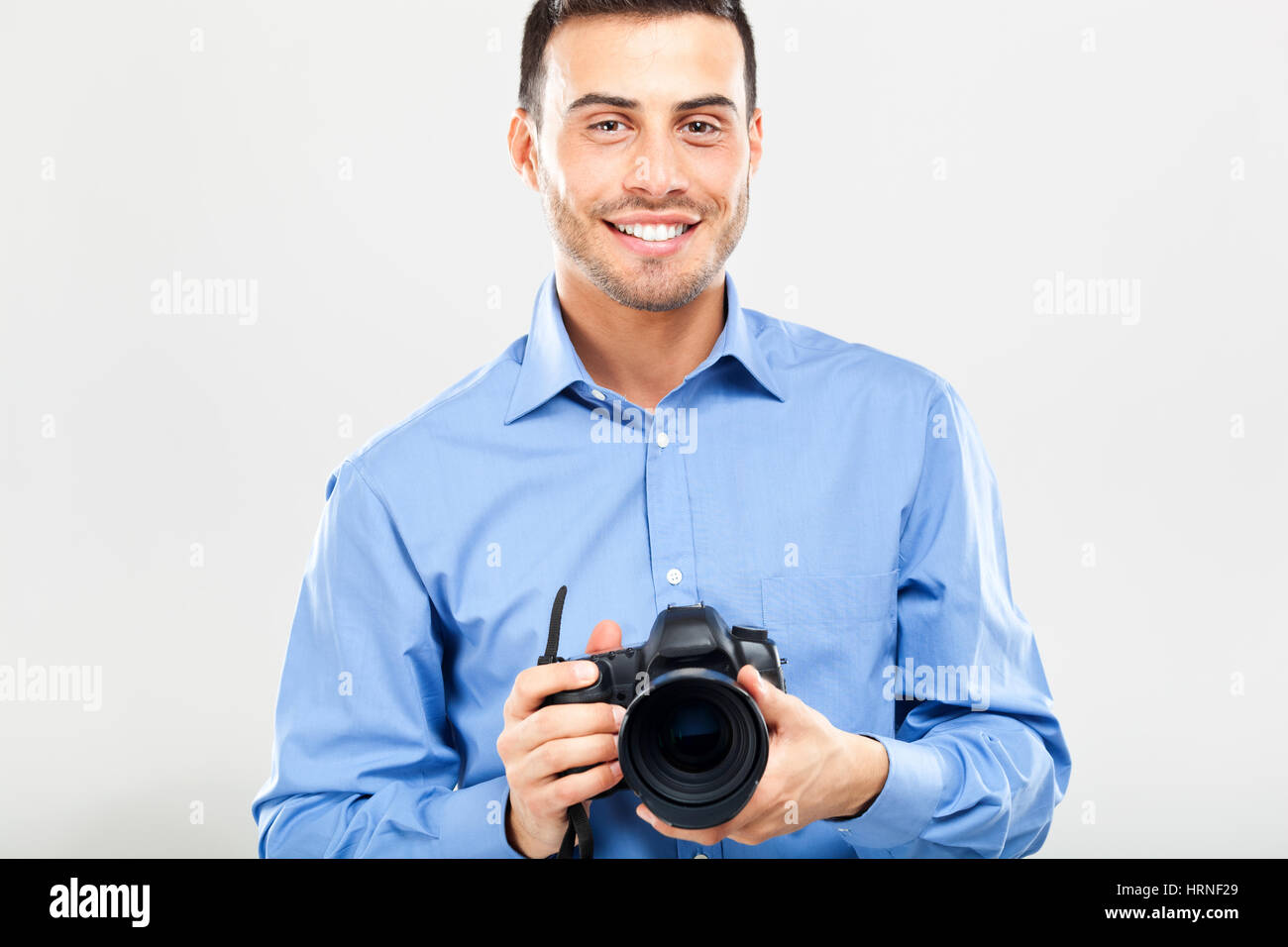 Smiling photographer using his camera isolated on white Stock Photo - Alamy