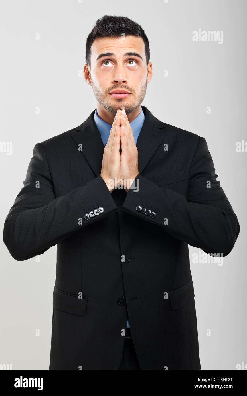 Businessman praying for something isolated Stock Photo - Alamy