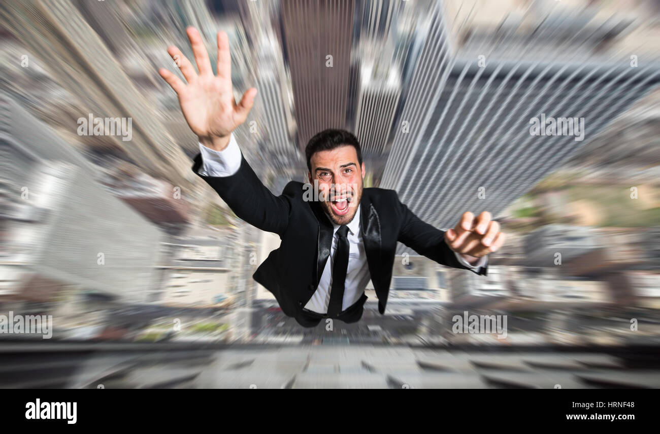 Businessman falling down from a tall skyscraper Stock Photo - Alamy