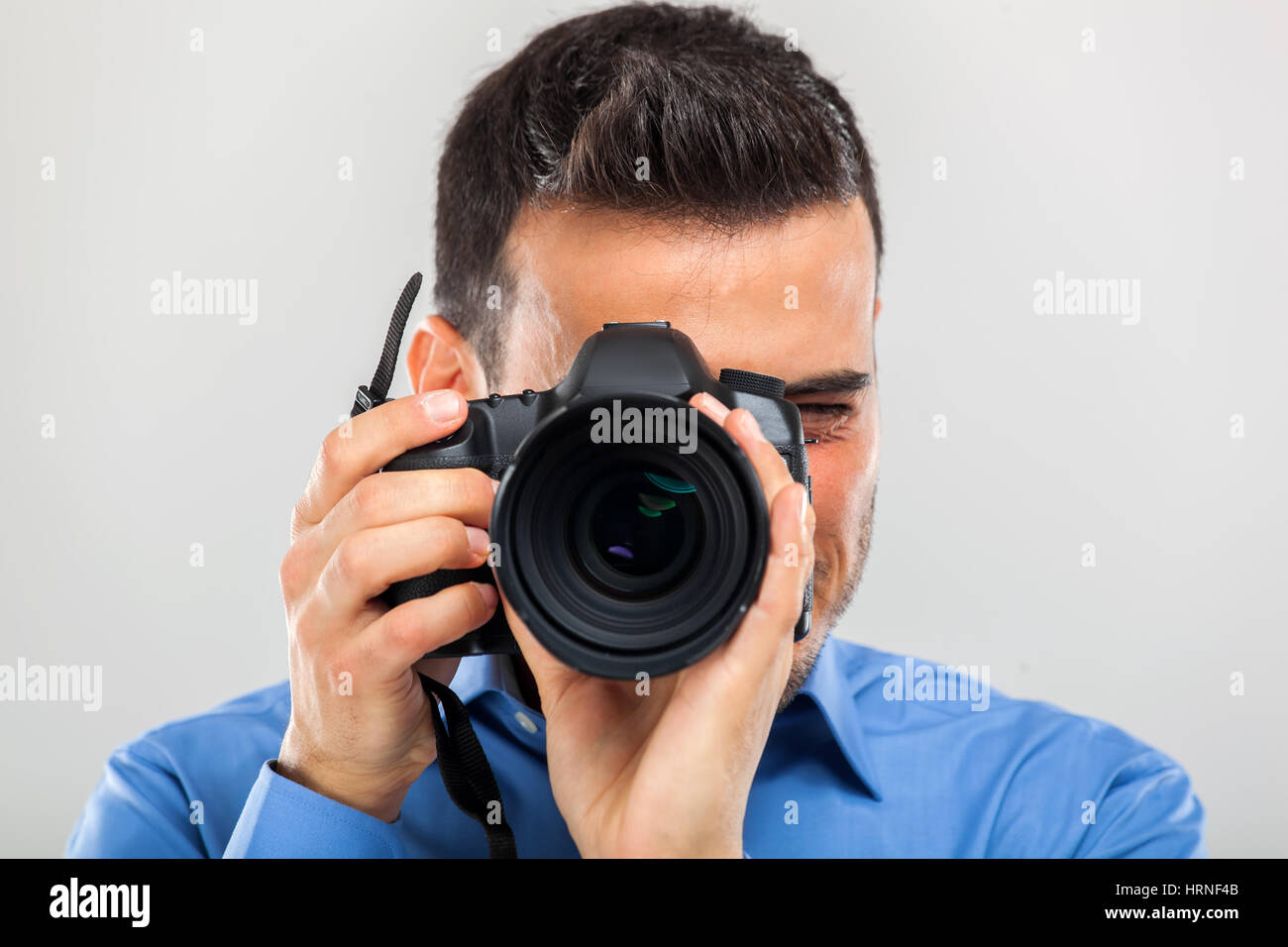 Photographer using his camera Stock Photo - Alamy