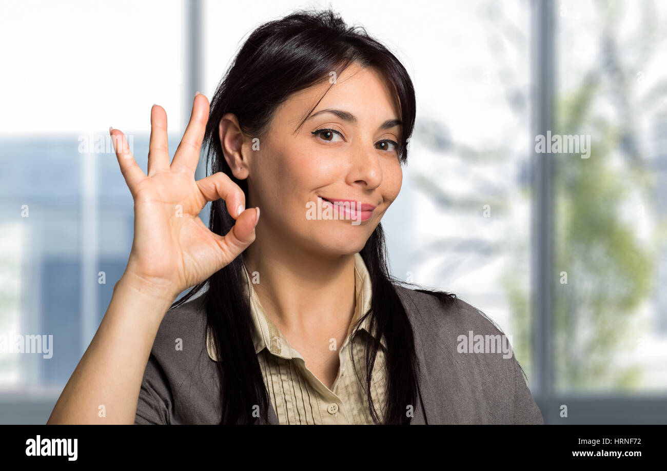 Portrait of beautiful girl showing OK sign and smiling Stock Photo - Alamy